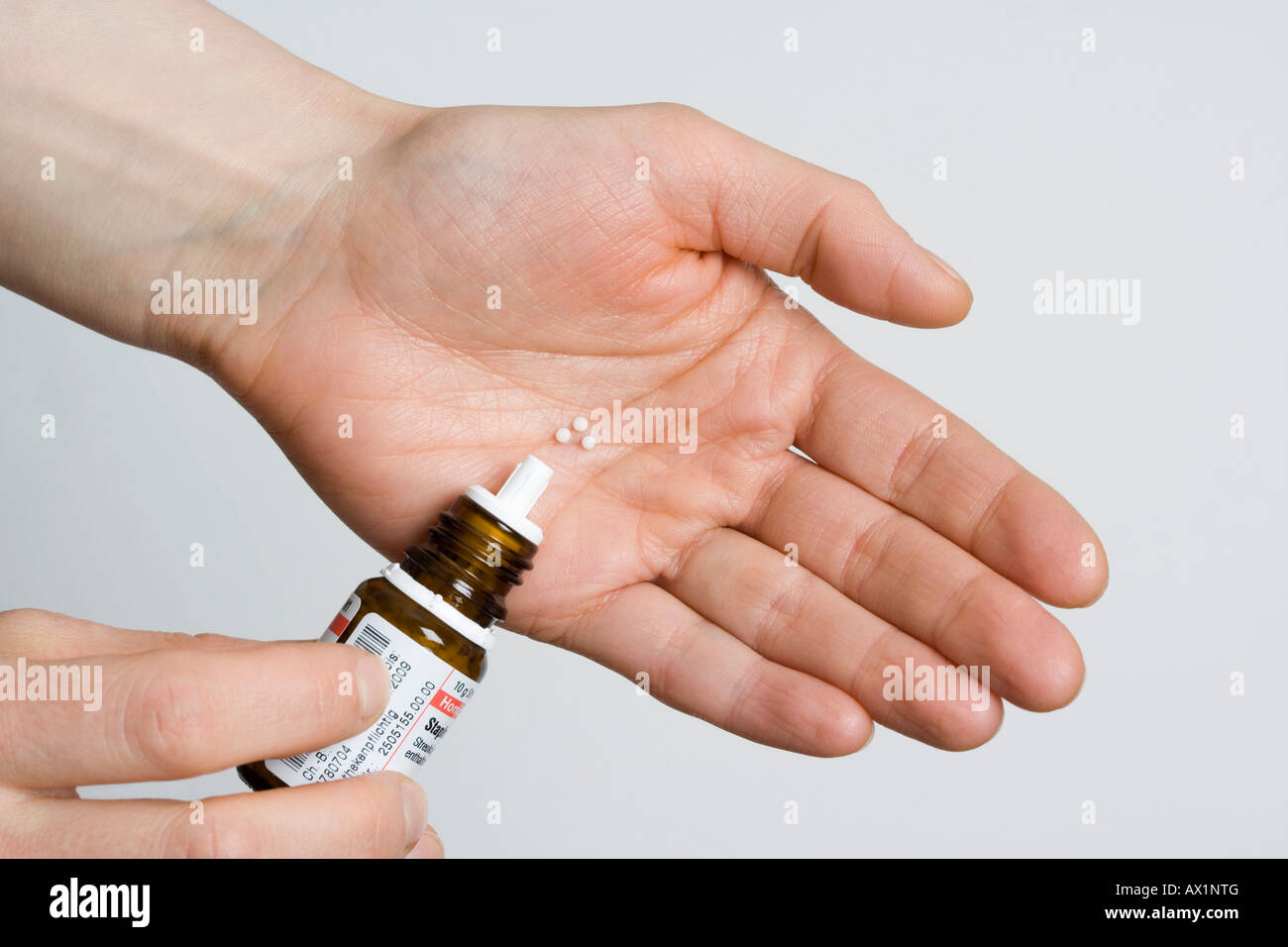 A hand holding homeopathic medicine Stock Photo - Alamy