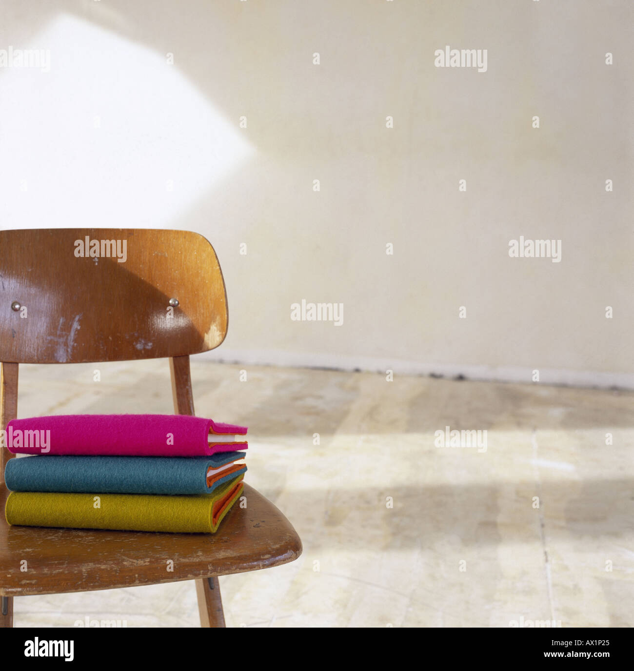 Stack of notebooks on chair Stock Photo - Alamy