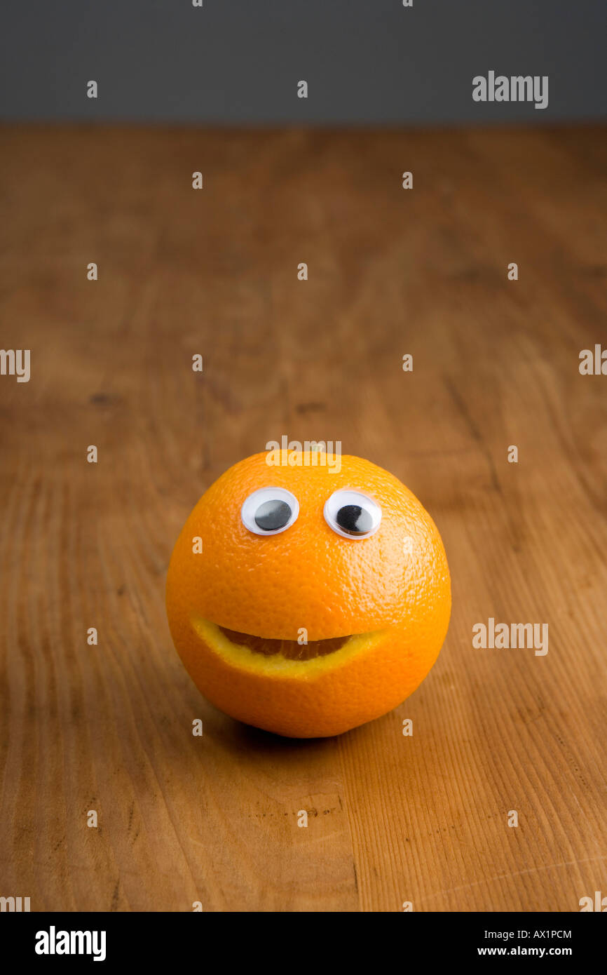 A smiley face on an orange Stock Photo - Alamy