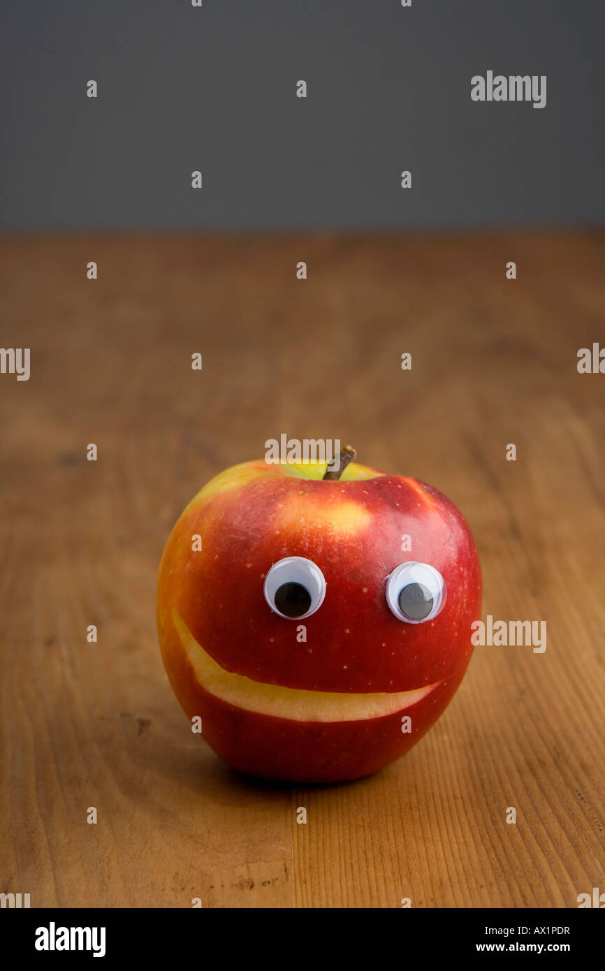 An apple with a smiley face Stock Photo - Alamy