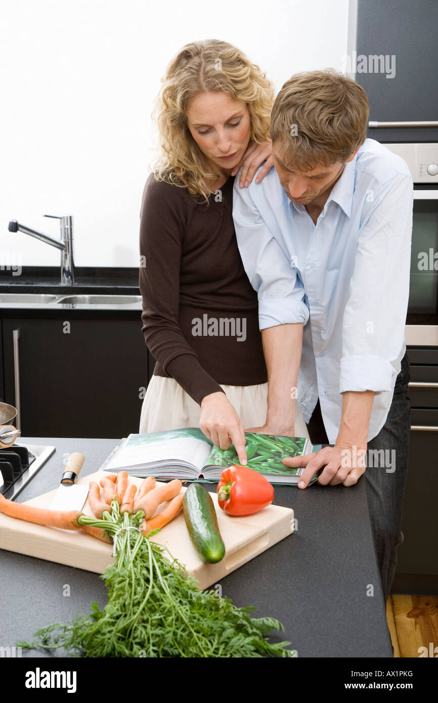 A couple preparing to cook in the kitchen Stock Photo - Alamy