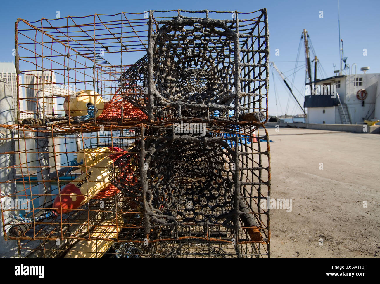Lobster traps are stacked on a wharf, ready for use in the commercial ...