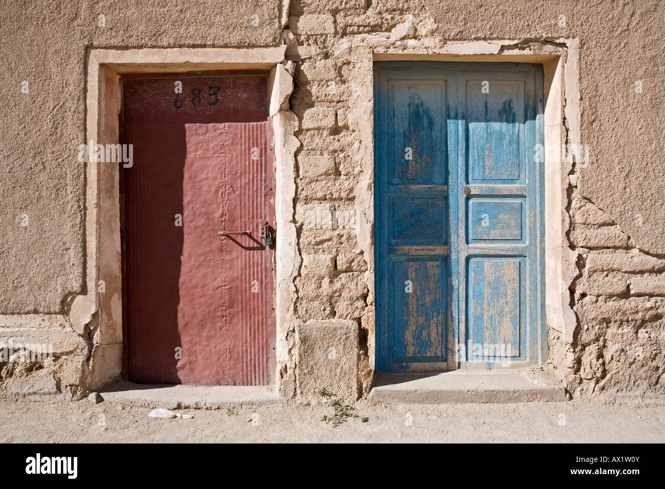 Decayed house facades with doors, city center of Uyuni, Altiplano ...