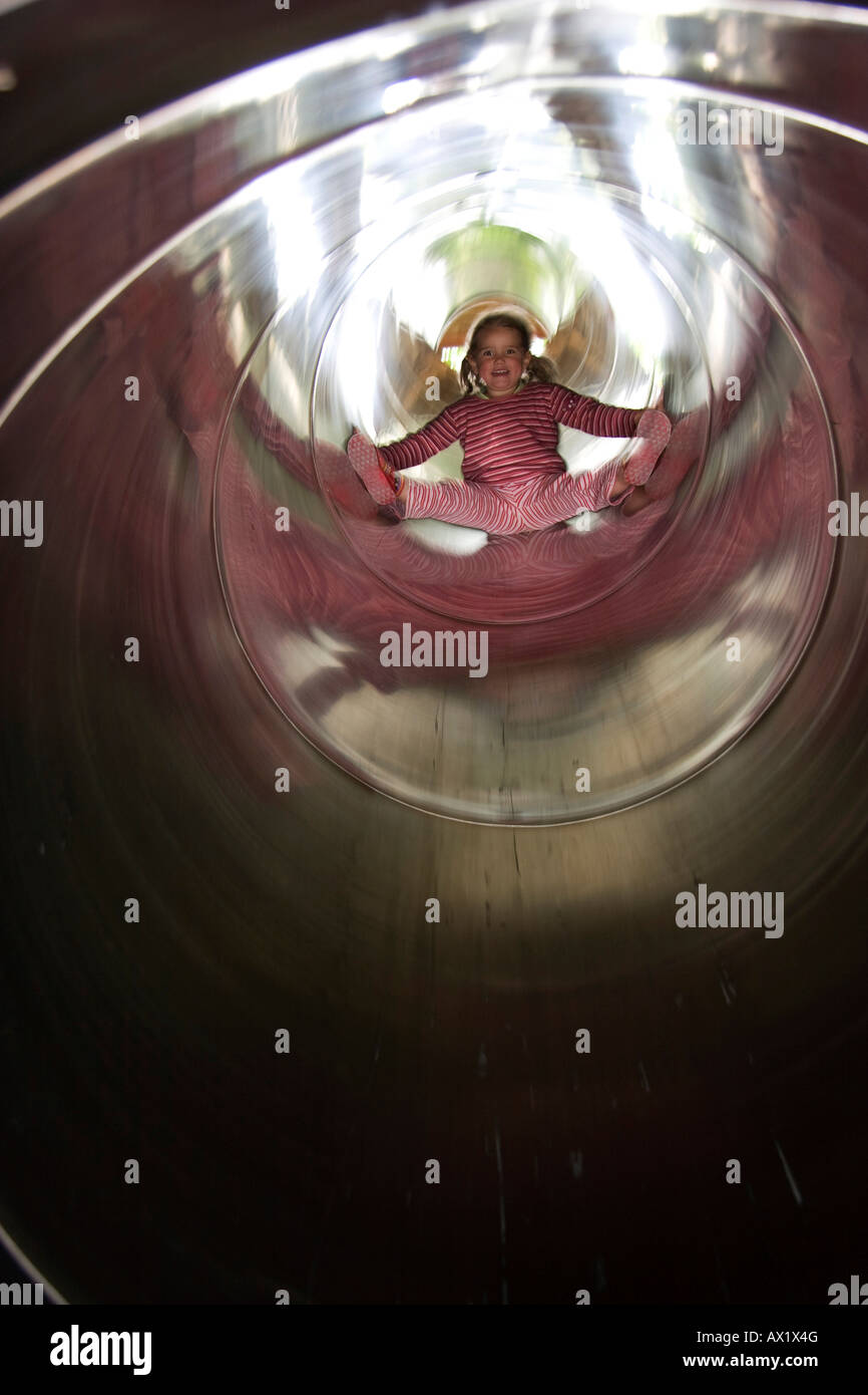 Young girl on a slide, playing Stock Photo - Alamy