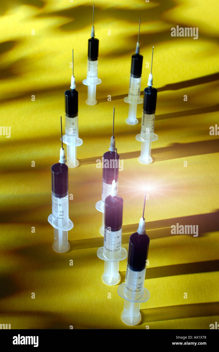 Multiple syringes with coloured background Stock Photo - Alamy