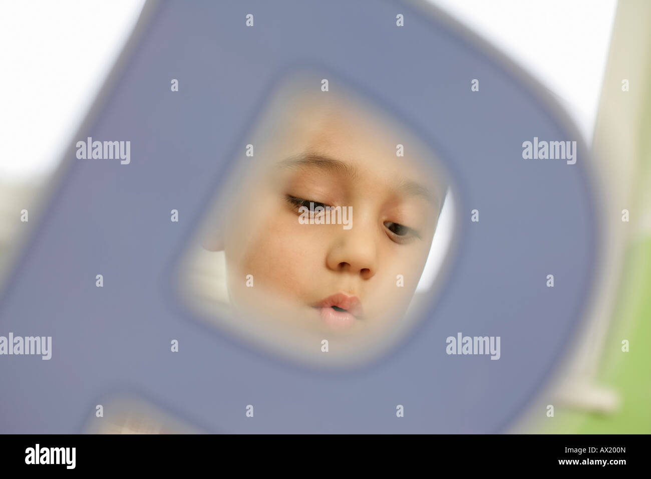 Little boy looking through a letter Stock Photo - Alamy