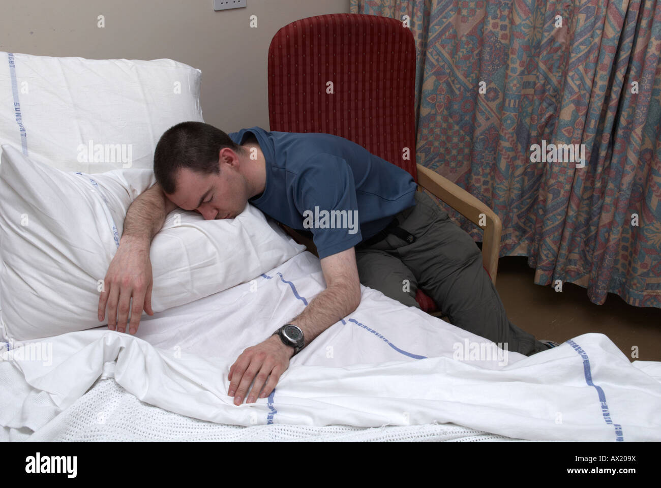 Man asleep / acting sad by empty bed in hospital Stock Photo - Alamy