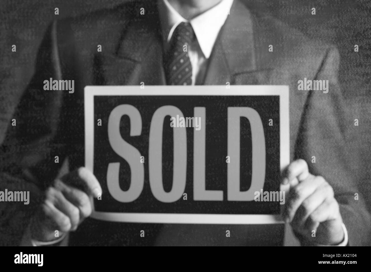 Man holding sold sign BE 2 Stock Photo - Alamy