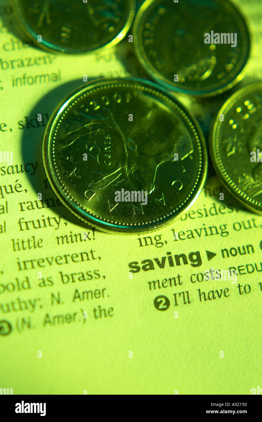 Definition of saving with coins BE Stock Photo - Alamy