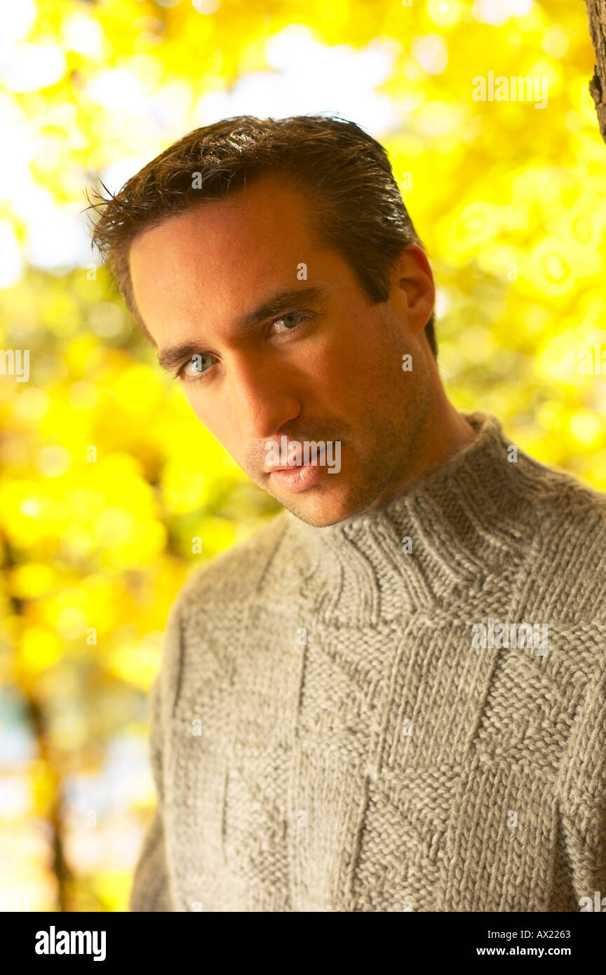 Man leaning against tree a82 Stock Photo - Alamy