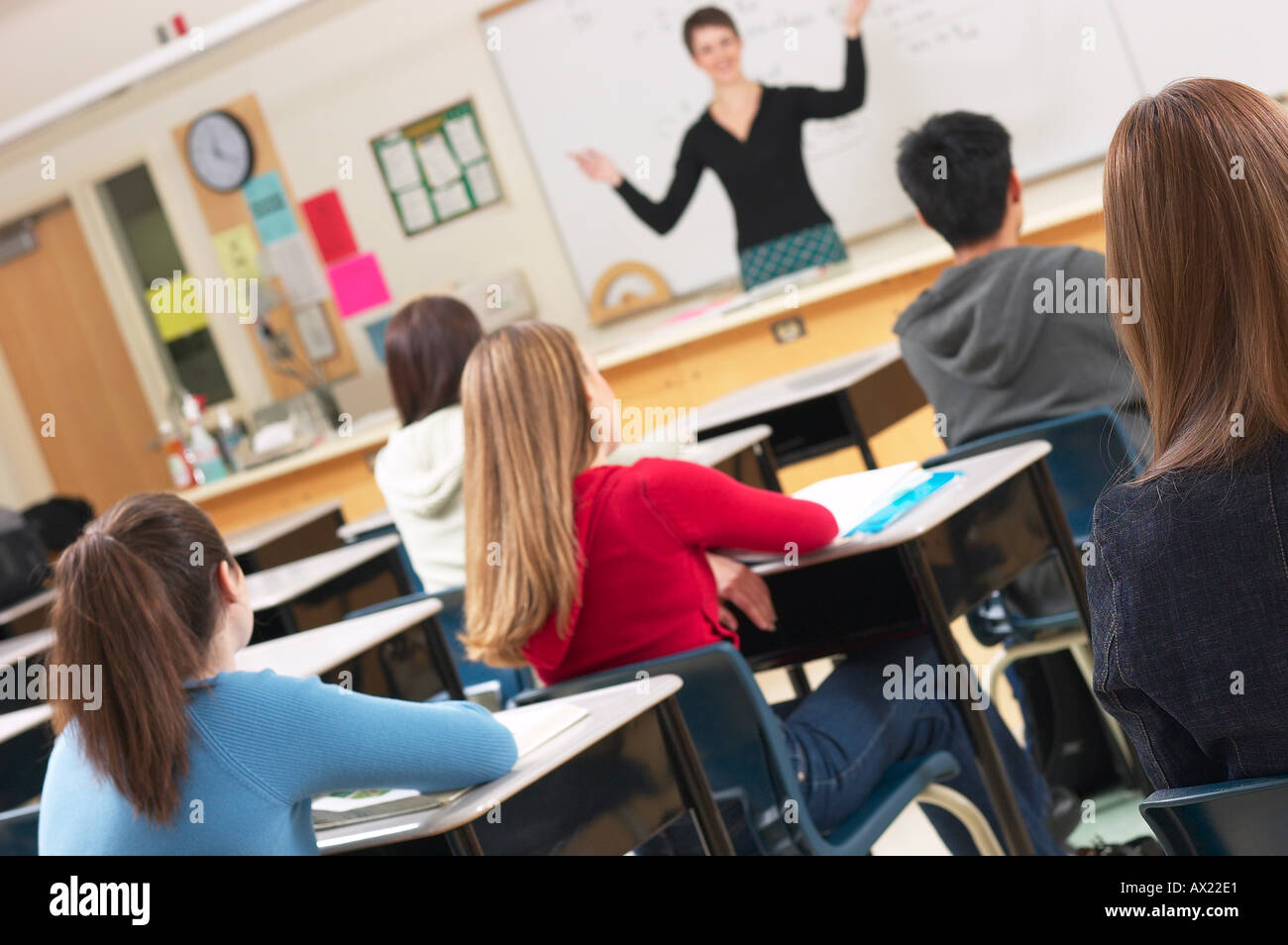 Teacher in classroom full of students a84 Stock Photo - Alamy
