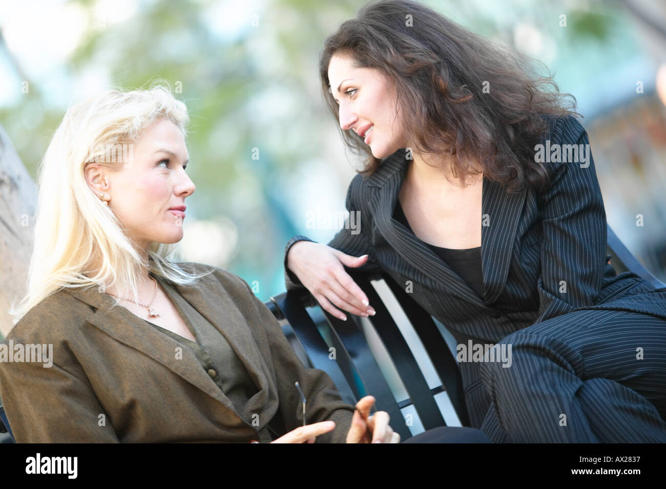 Two women seated on bench hi-res stock photography and images - Alamy