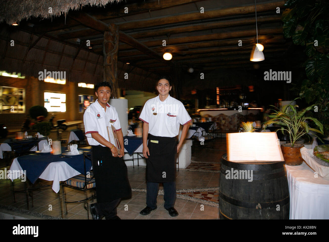 Waiters in front of restaurant on 5th Avenue at Night Playa del Carmen ...
