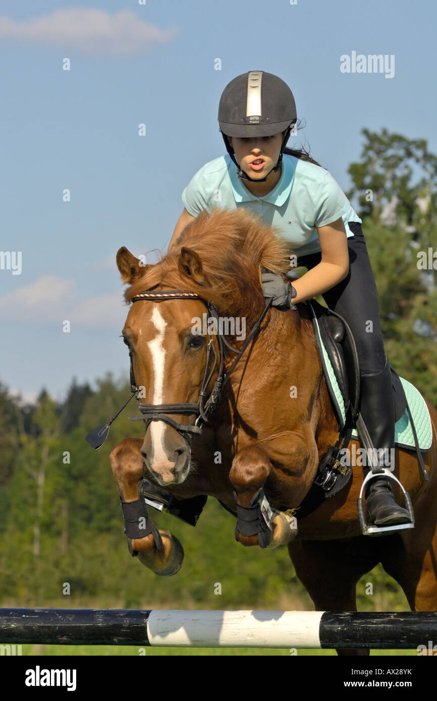 Girl riding pony jumping on hi-res stock photography and images - Alamy