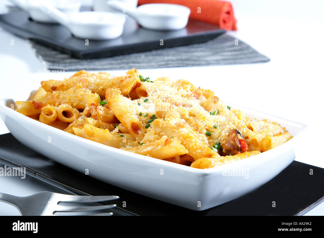 Penne au gratin with fish seafood and grated cheese Stock Photo - Alamy
