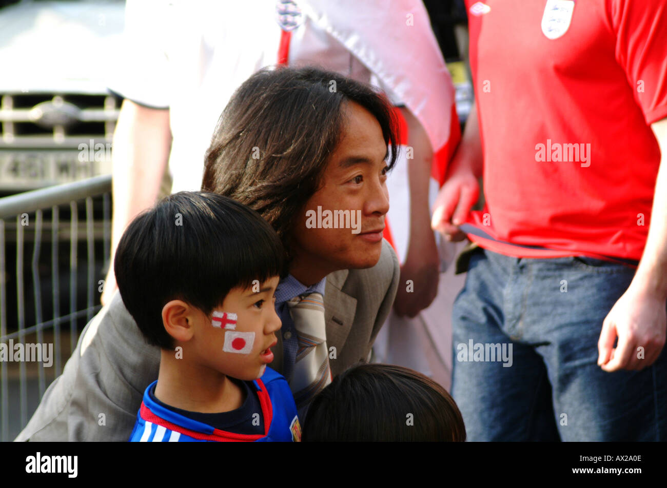 A Japenese sports celebrity poses for a shot with a fan before the ...