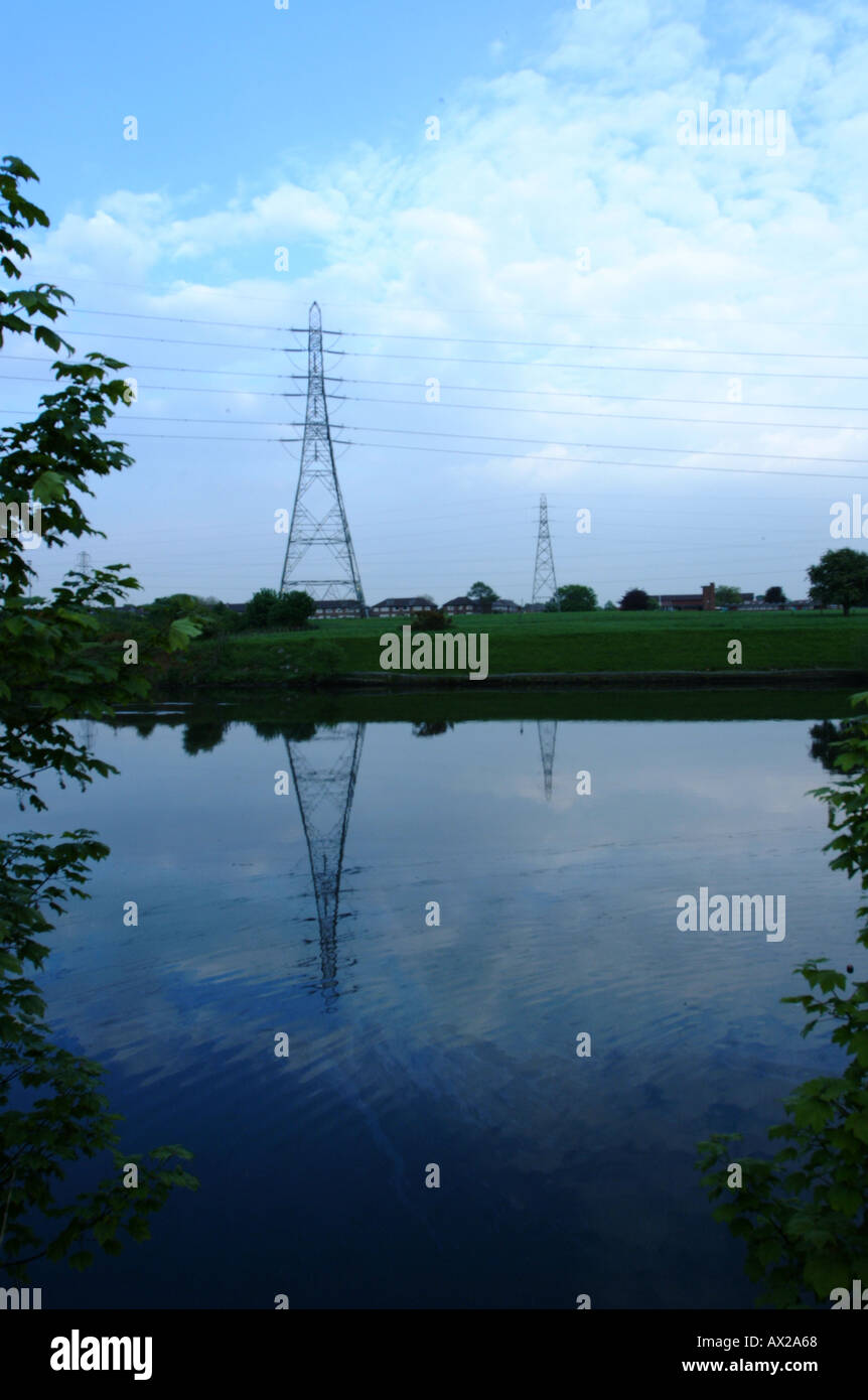 Reflection of an electricity pylon in the manchester ship canal england ...