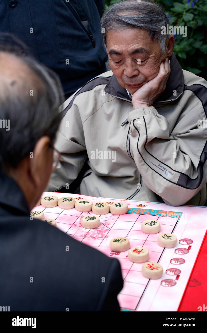 Two elderly Chinese men playing xiangqi/Chinese chess at the Mid-Autumn ...