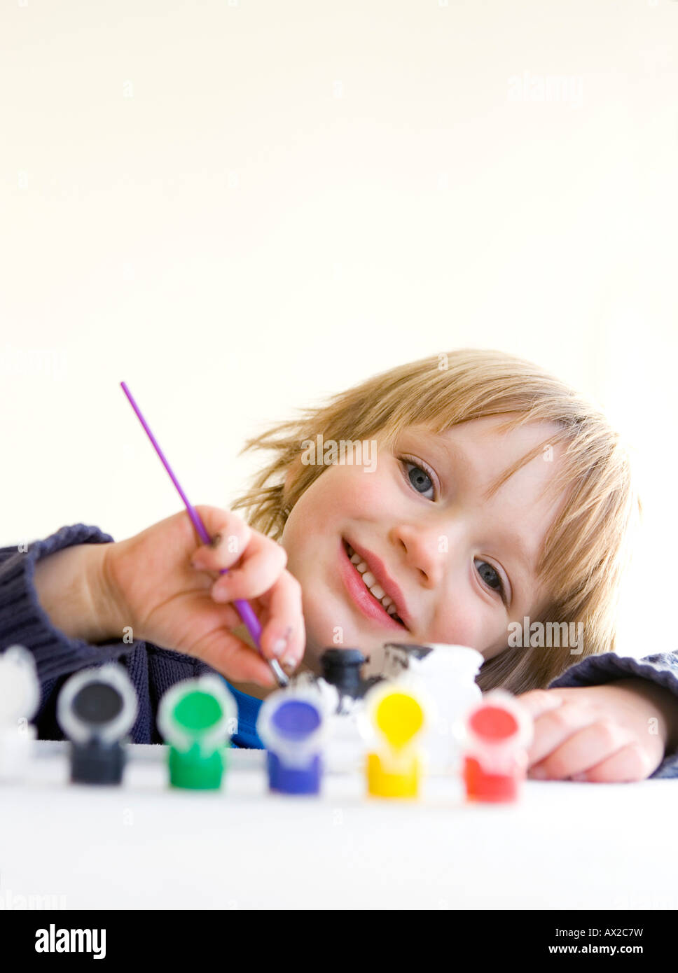 A boy painting with coloured paint at home Stock Photo - Alamy
