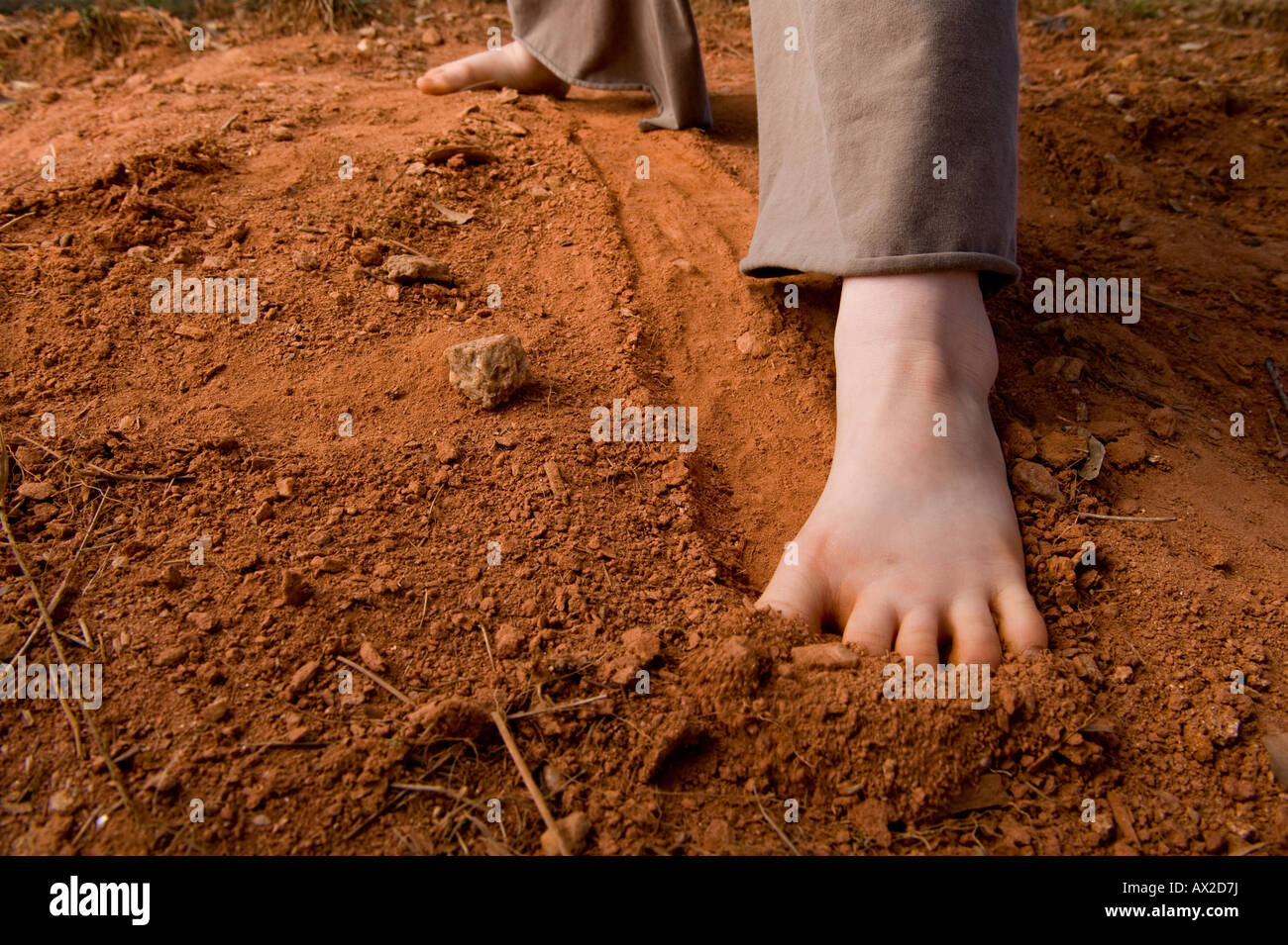 A young girl digs her toes into the red dirt Stock Photo - Alamy