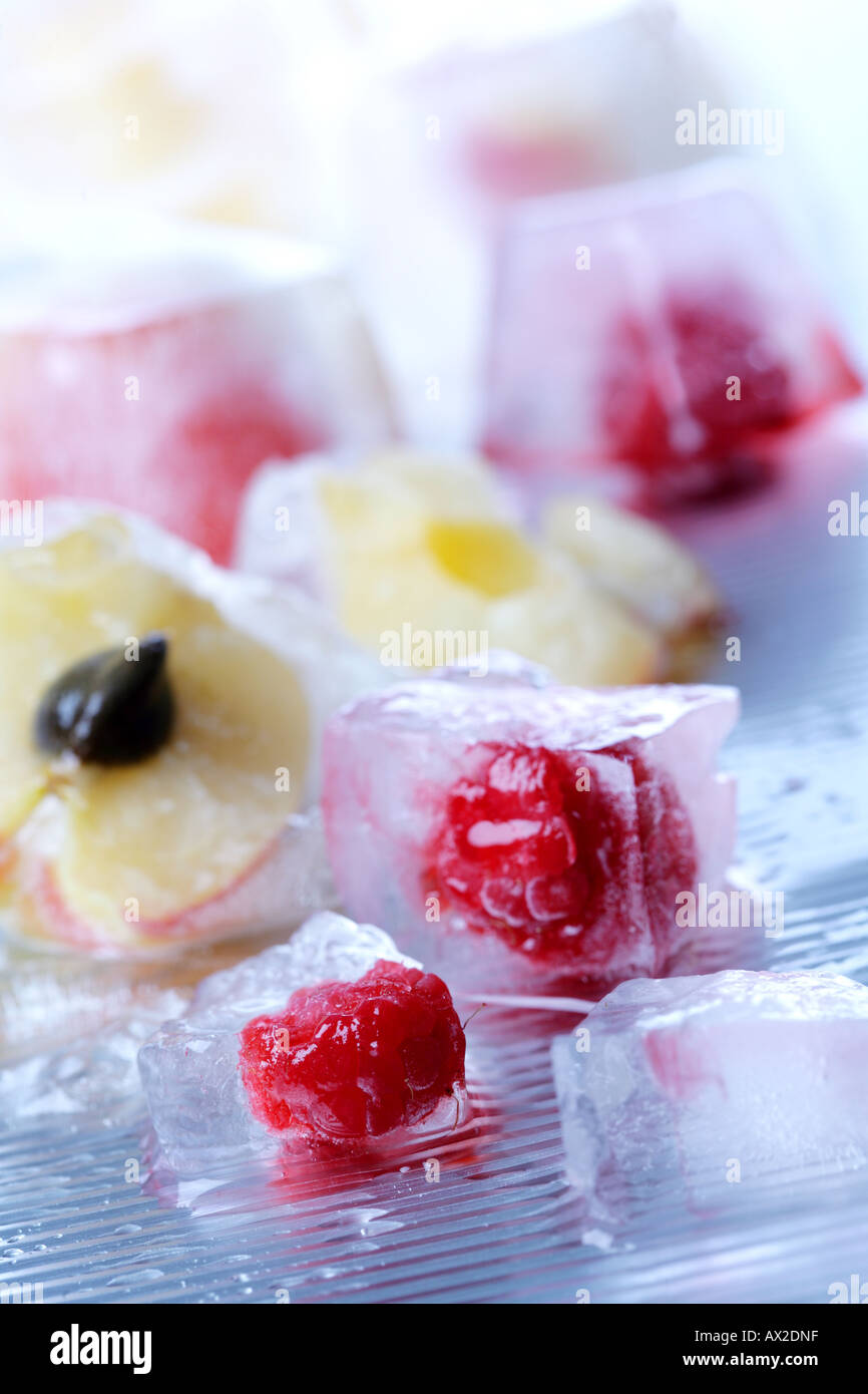 Frozen apricot and raspberries into a broken ice cubes Stock Photo - Alamy