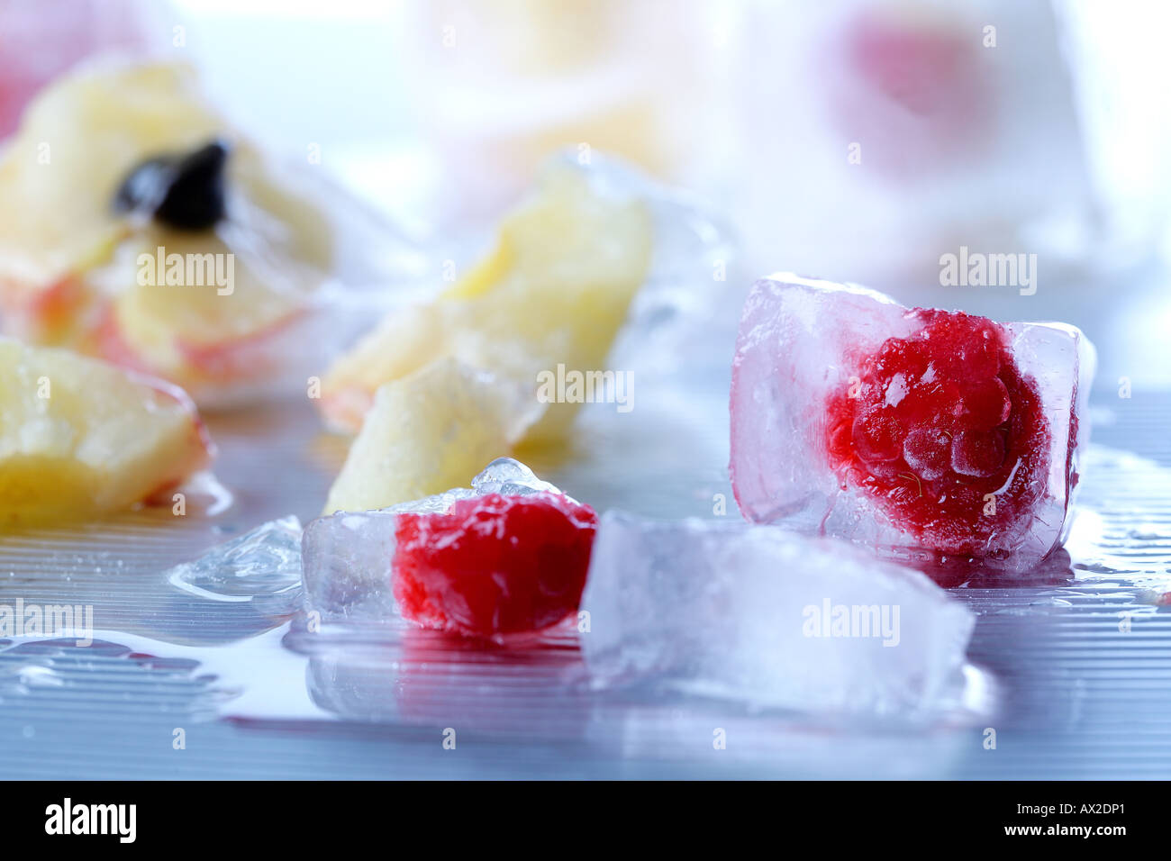Frozen apricot and raspberries into a broken ice cubes Stock Photo - Alamy
