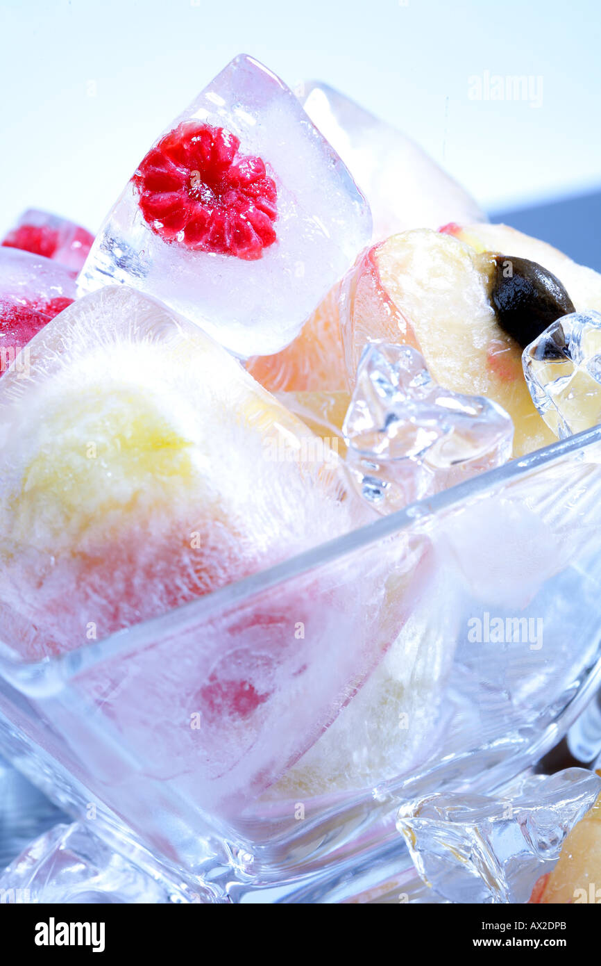 Frozen apricot and raspberries into a broken ice cubes Stock Photo - Alamy