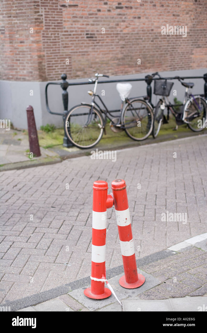 two sign street painted in white and red stripes on the sidewalk of an ...