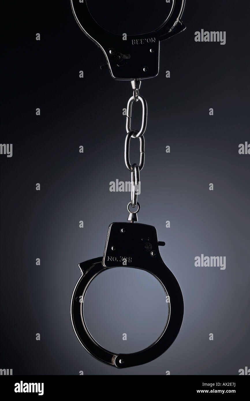a pair of handcuffs Stock Photo - Alamy