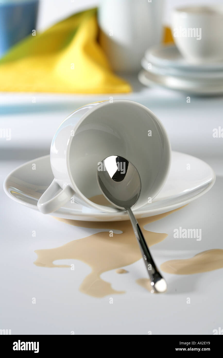 White coffee spilled from its fallen cup Stock Photo - Alamy