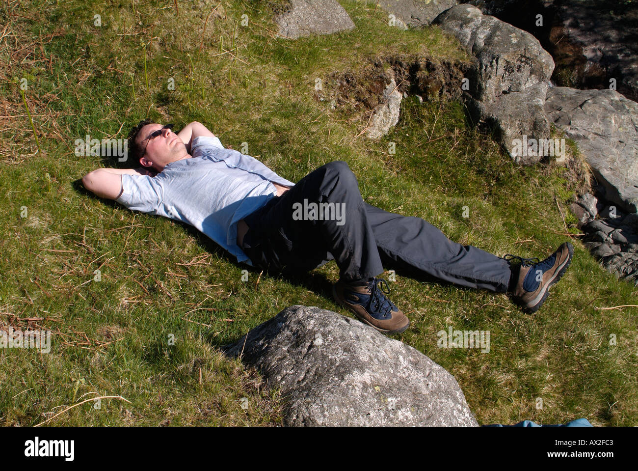 Fellwalker alseep in the rocks Stock Photo - Alamy