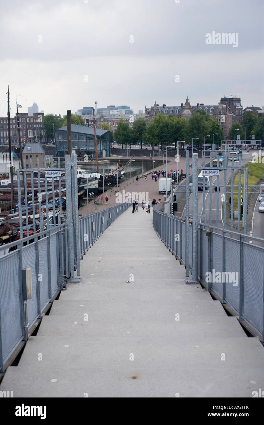 pedestrian bridge with concrete stairs and steal blue banister in the ...