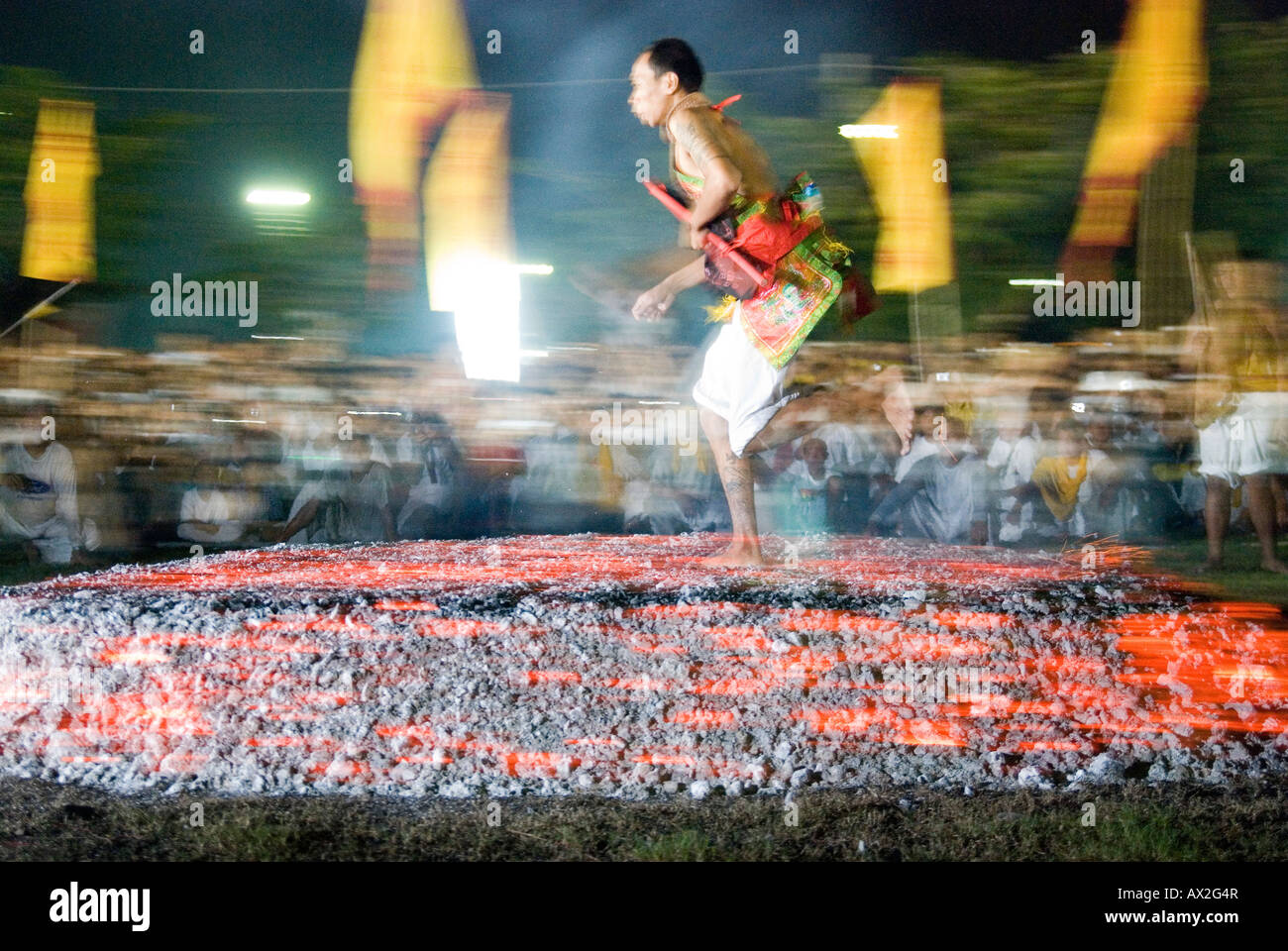 A medium fire walking on hot coals in the Phuket Vegetarian Festival ...