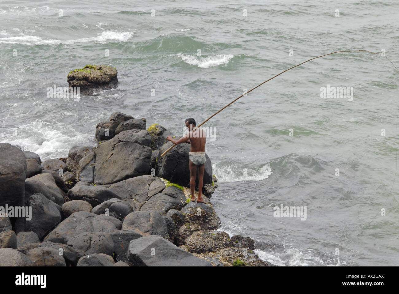 A man fishing in sea Stock Photo - Alamy