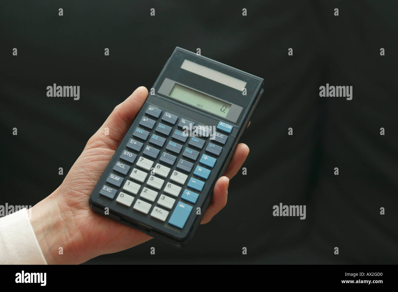 A hand holding a calculator Stock Photo - Alamy