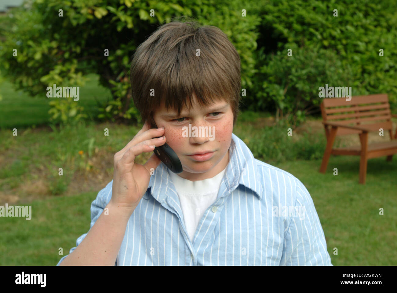 A school boy using mobile phone cell phone Stock Photo - Alamy