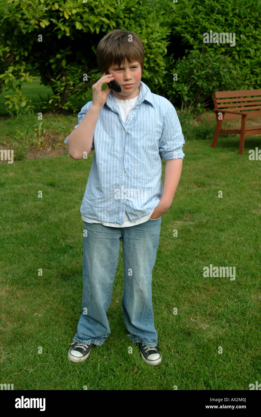 A school boy using mobile phone Stock Photo - Alamy