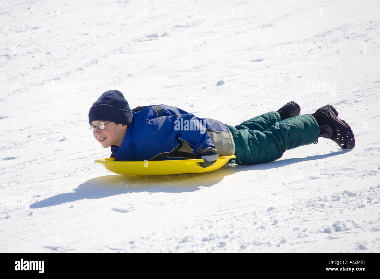Boy Snow Sledding Stock Photo - Alamy
