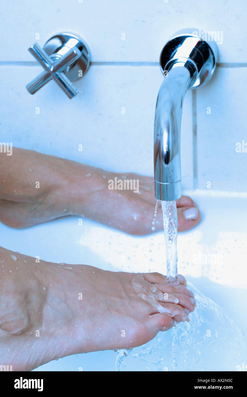 washing feet under running water from tap Stock Photo - Alamy