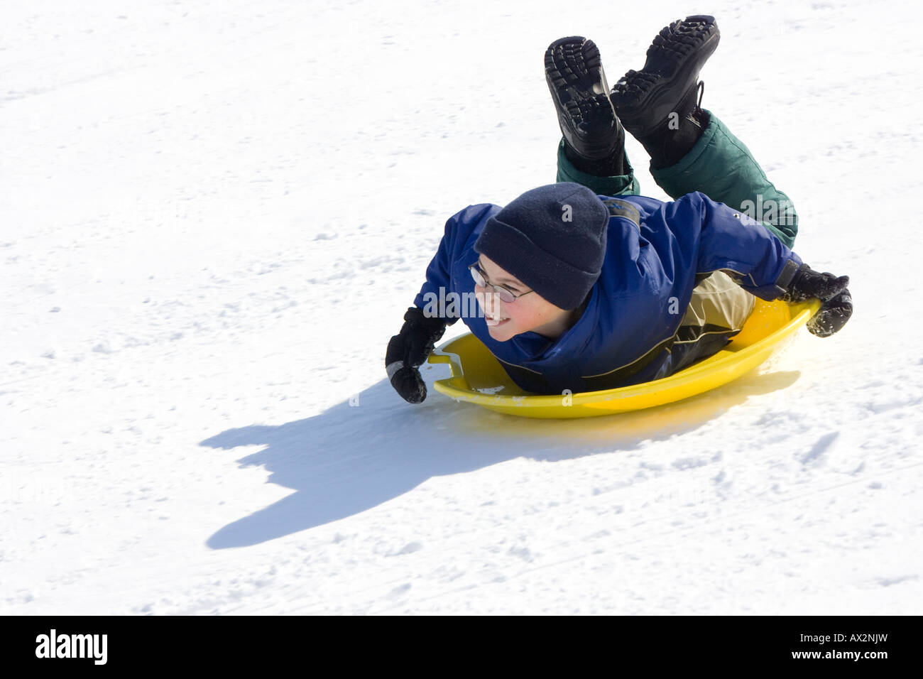 Boy sledding Cut Out Stock Images & Pictures - Alamy