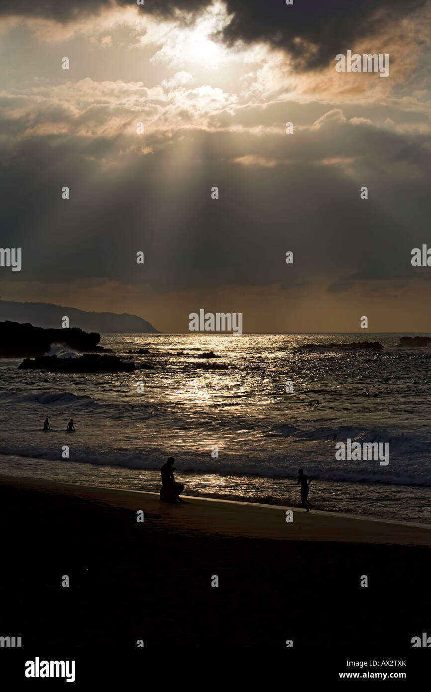 Beach sunset mono subdued colors. Ray of sun reflection on ocean water ...