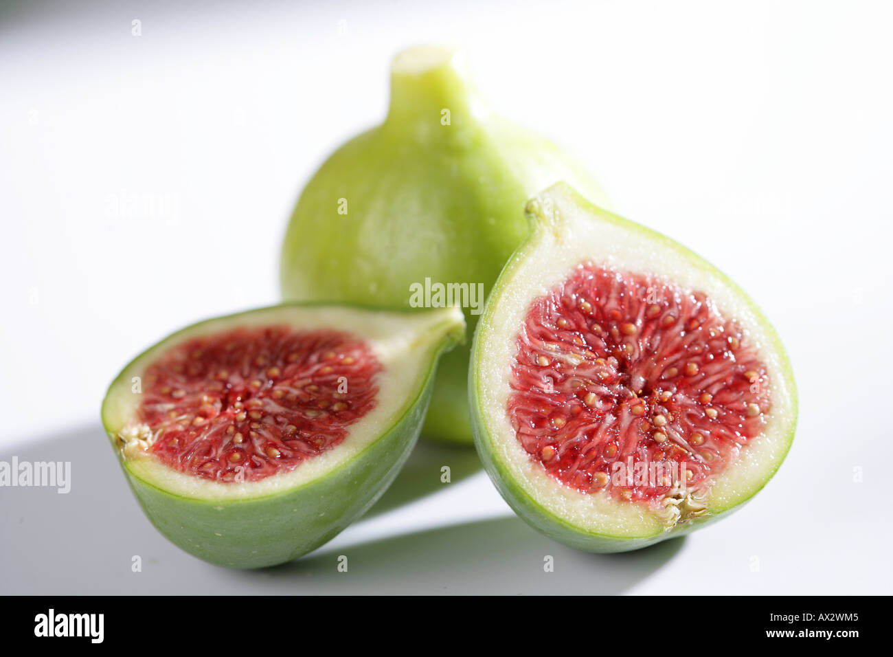 Close up of an opened fig with whole fig and white background Stock ...