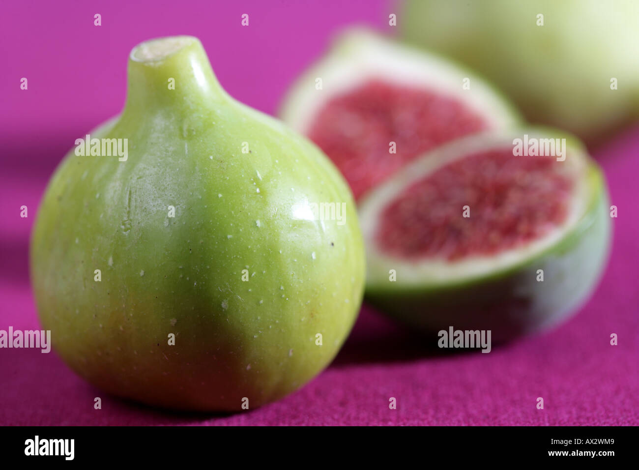 Whole figs with opened figs and purple background Stock Photo - Alamy