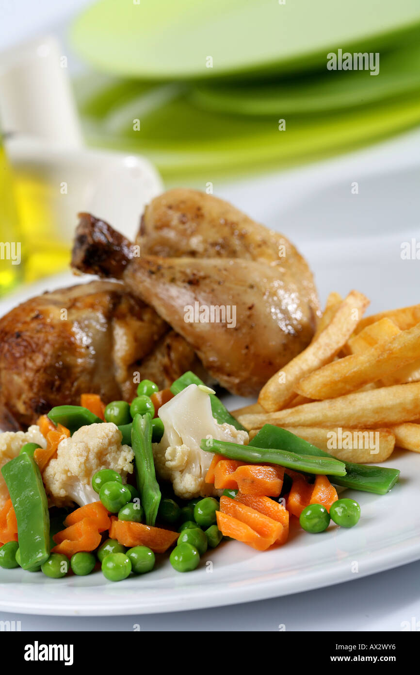 Mixed main course with half roast chicken French fries and vegetables ...