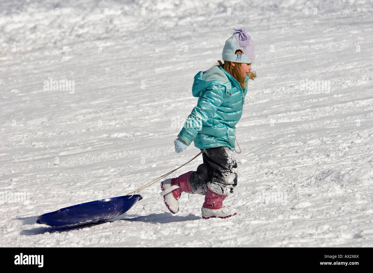 Child pulling sled up hill hi-res stock photography and images - Alamy