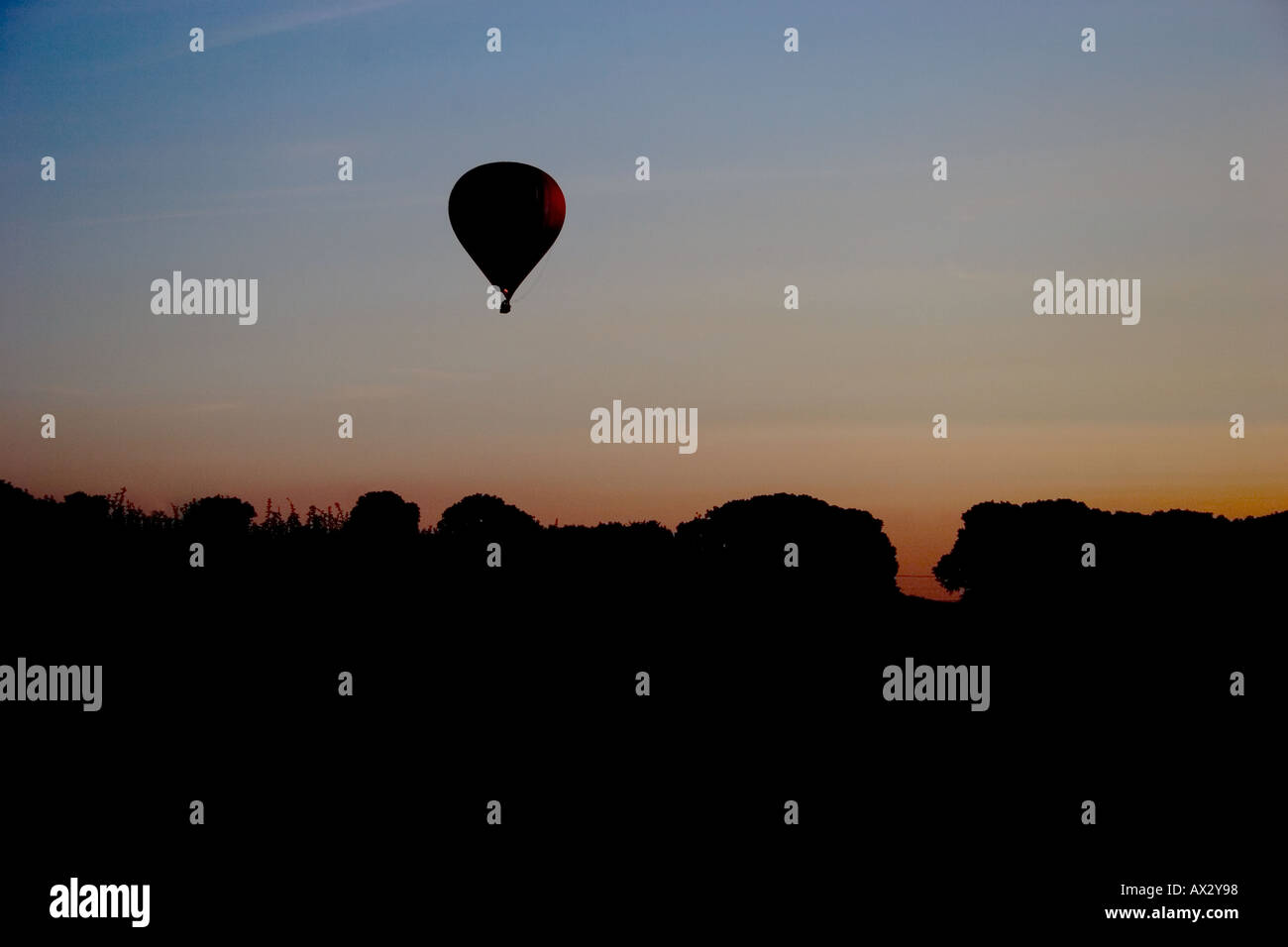 Balloon flying overhead at sunset Stock Photo - Alamy