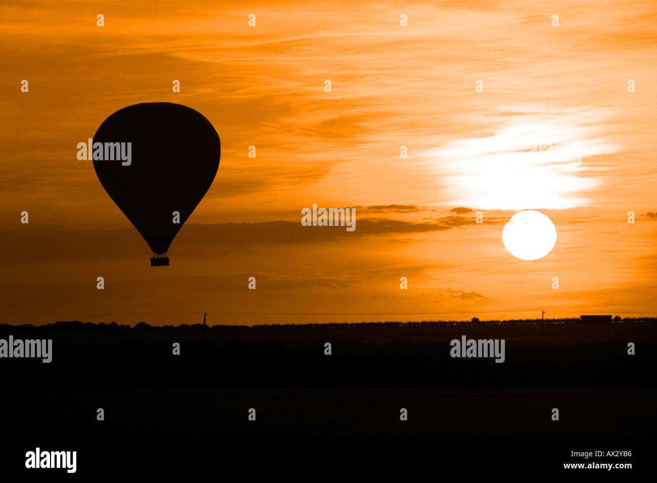 Balloon flying overhead at sunset Stock Photo - Alamy