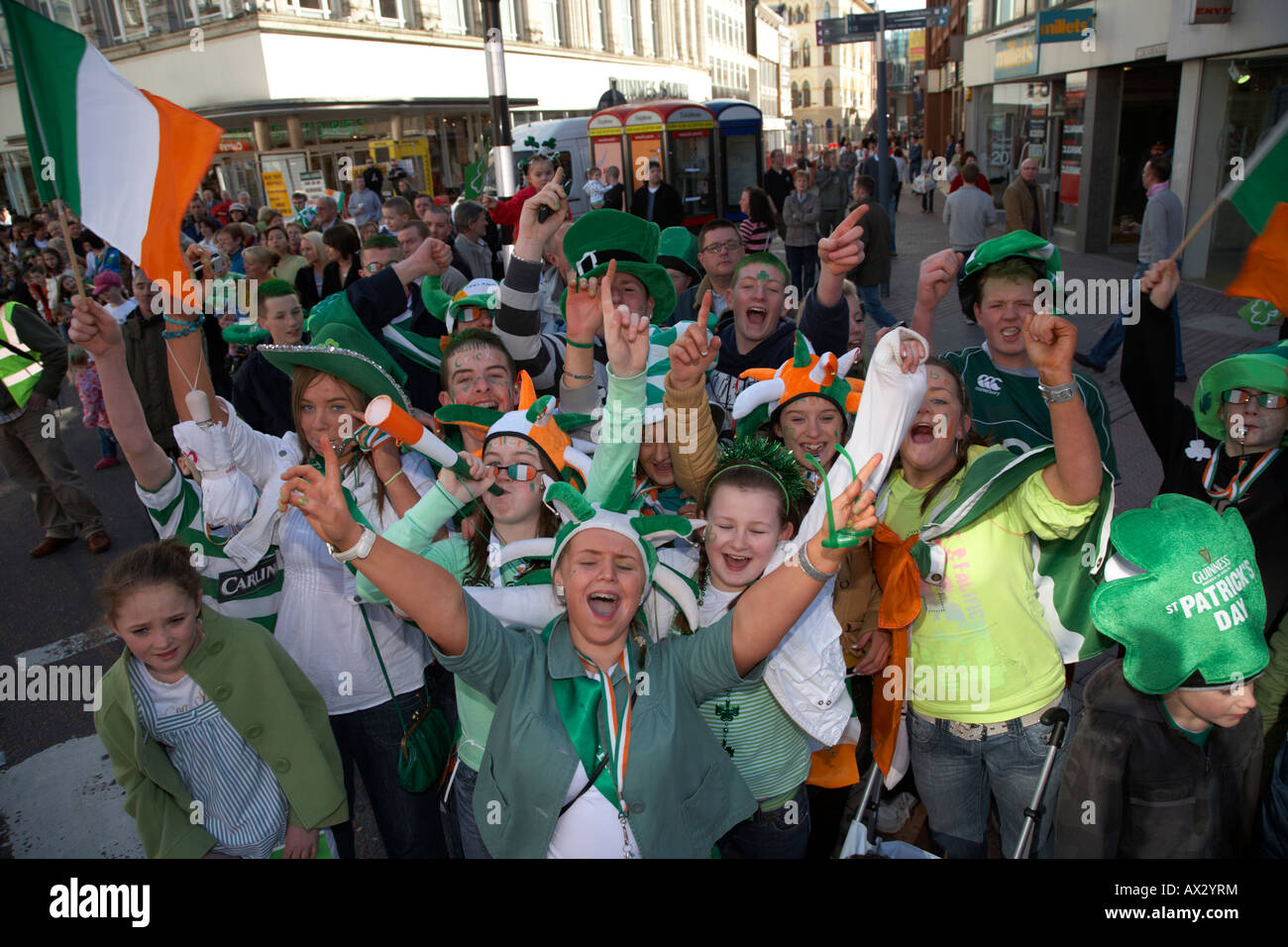 crowd of teenagers with irish flags standing waiting on the parade and ...