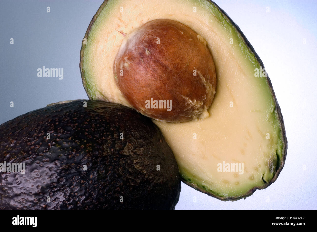avocado cut in half with pit seed Stock Photo - Alamy