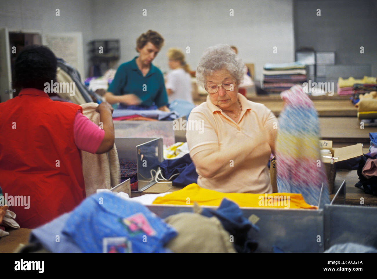 Volunteers Sort Clothing Donated for Disaster Victims Stock Photo - Alamy